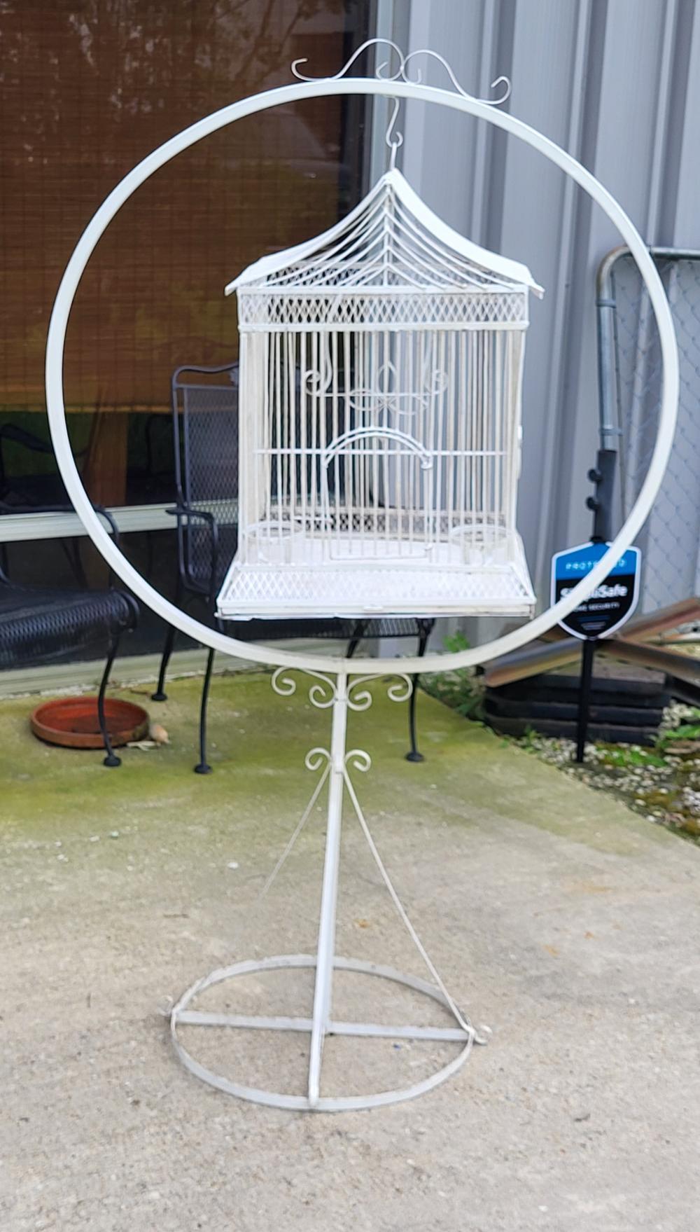 At Auction: wrought Iron antique Bird Cage on circular Stand