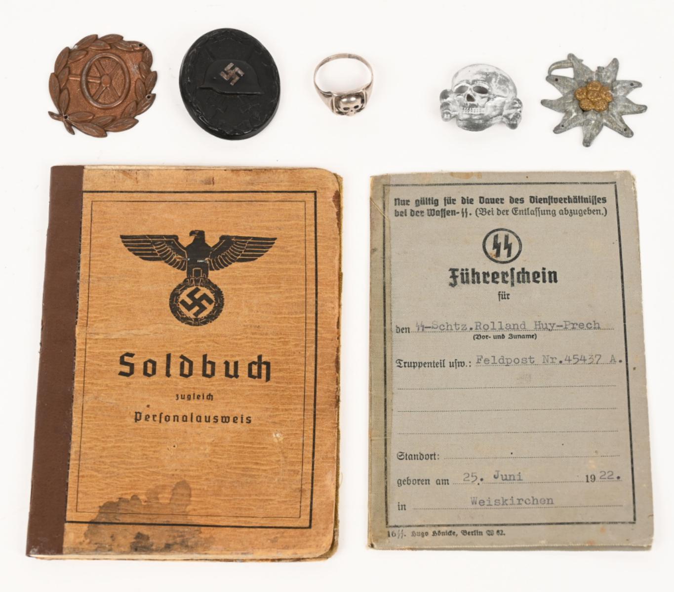 At Auction: WWII NAZI GERMAN WAFFEN SS SOLDBUCH & INSIGNIA LOT