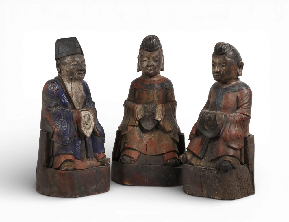 Lot - Three Chinese polychrome painted carved wood seated figures