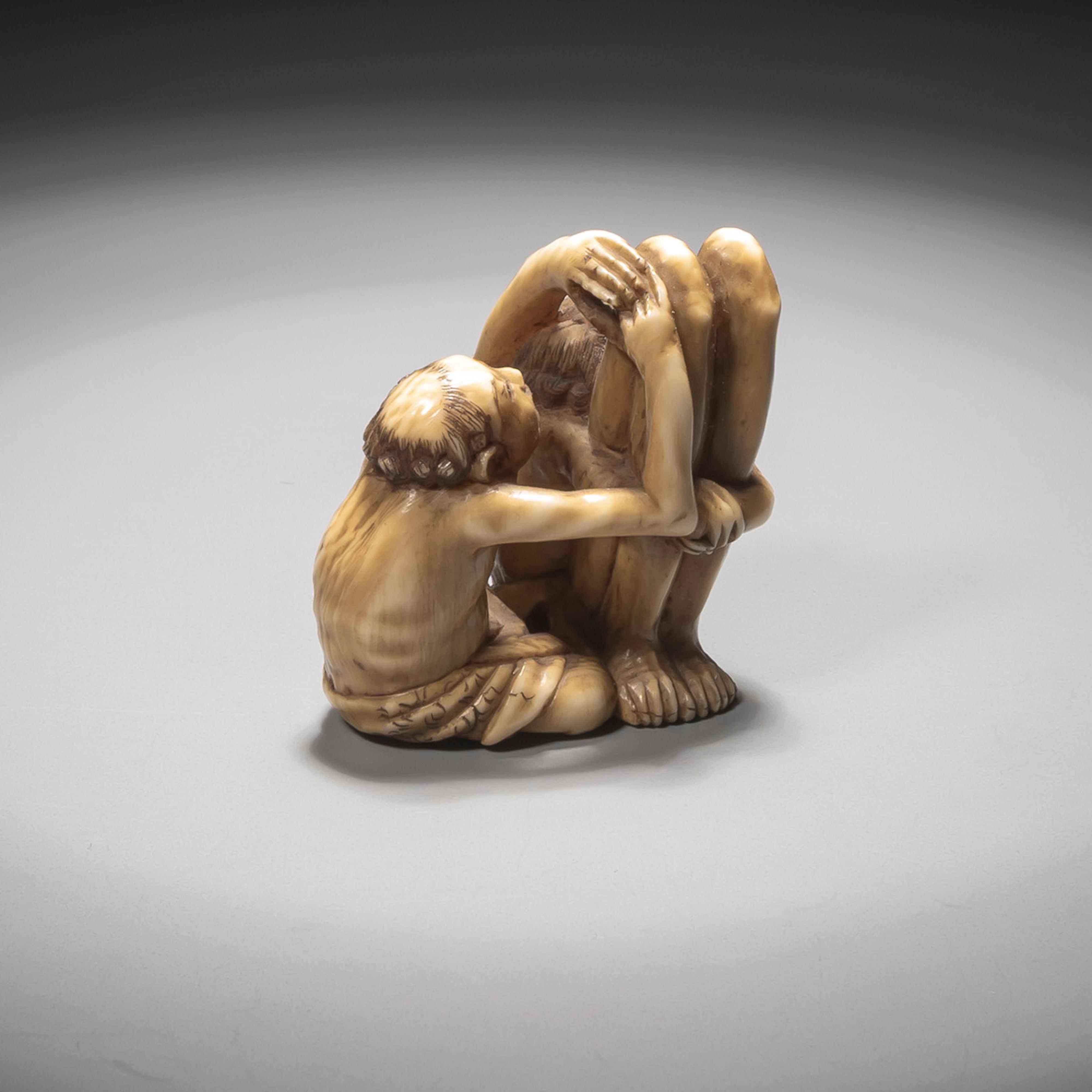 Lot - A carved ivory netsuke depicting Ashinaga and Tenaga